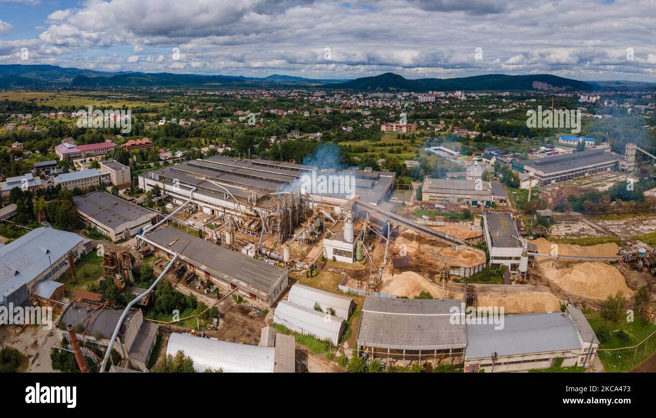 Aerial view of wood processing factory with smoke from production ...