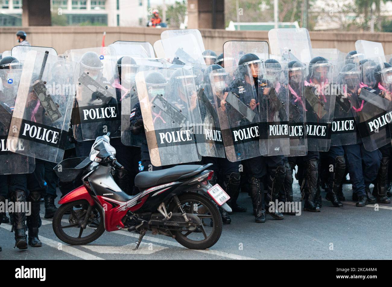 Riot police officers walk in formation during a rally in Bangkok as ...