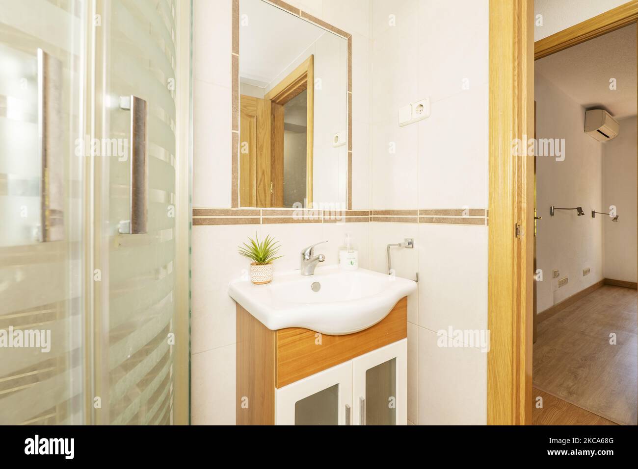 Bathroom with shower cabin, mirror embedded in the wall, porcelain ...