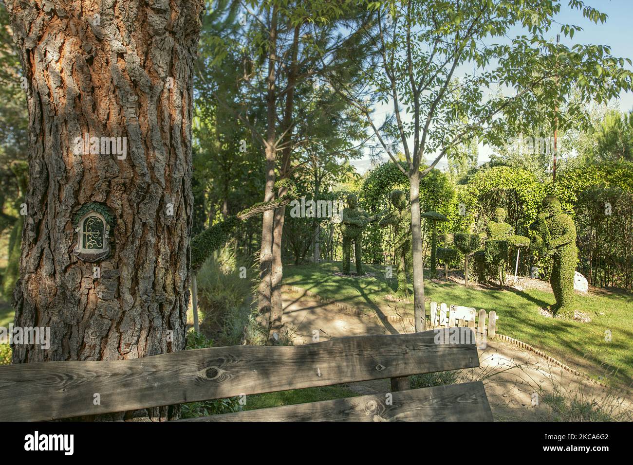 Park with trees, benches and figures of topiary art Stock Photo - Alamy