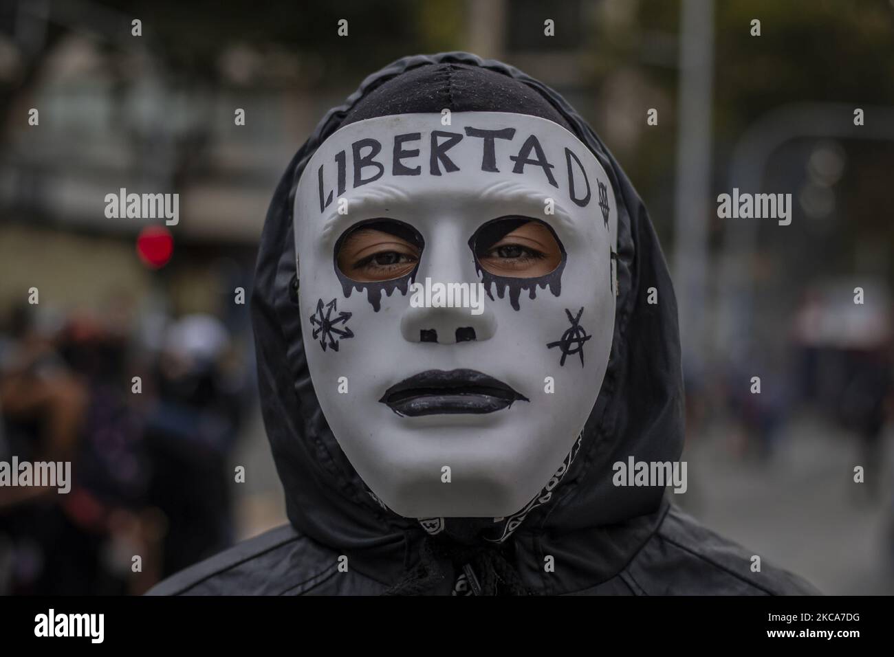A person wears a mask with the phrase freedom, Amid of the ...