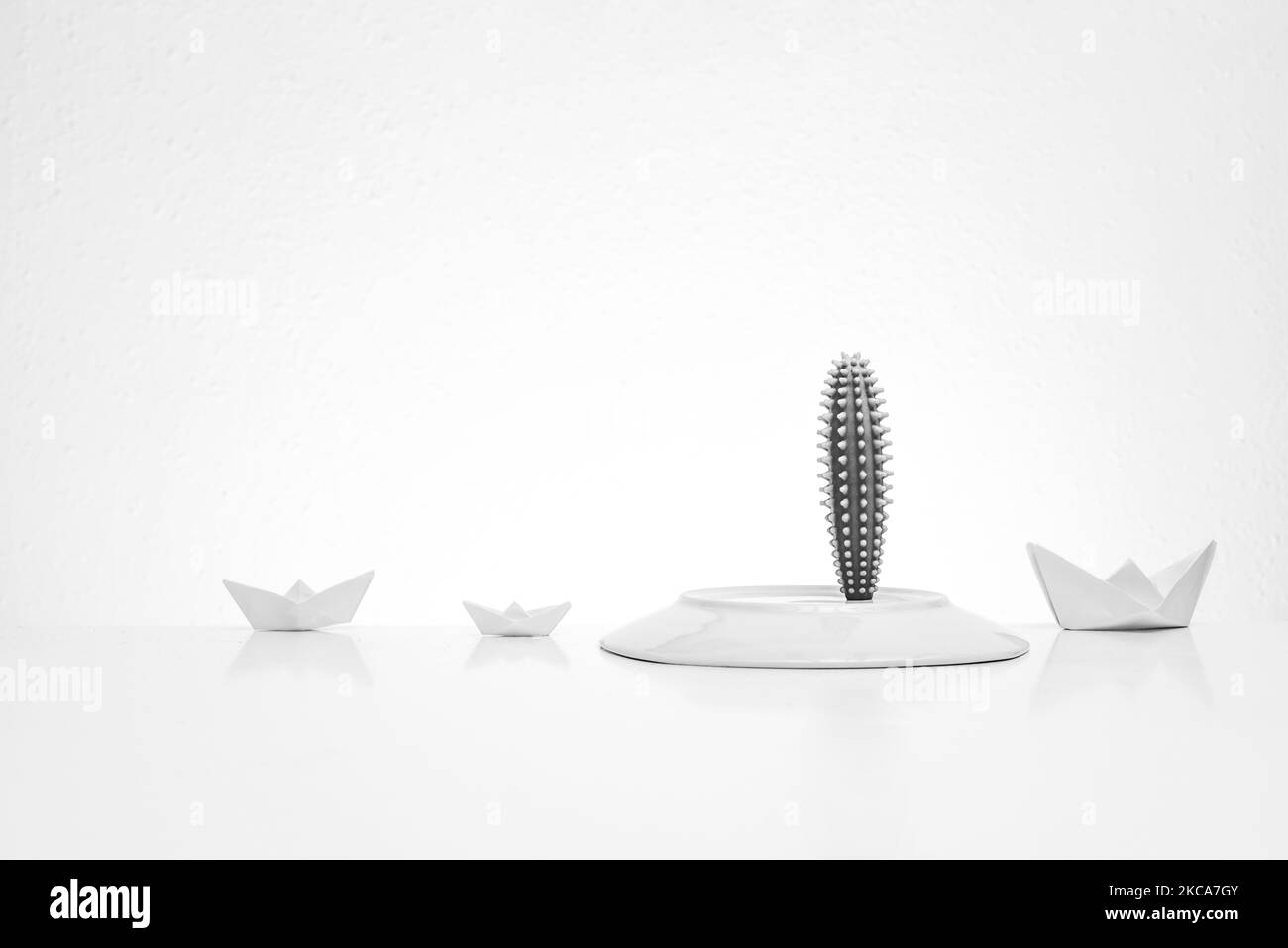 Decorative still life in white and gray tones with paper plates and ...