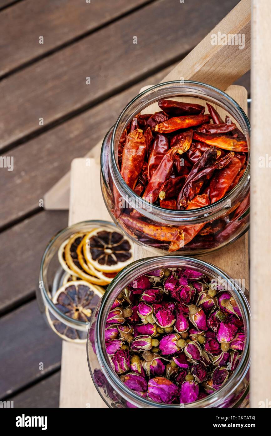 Top view image of a glass jar filled with dried tea roses and another ...