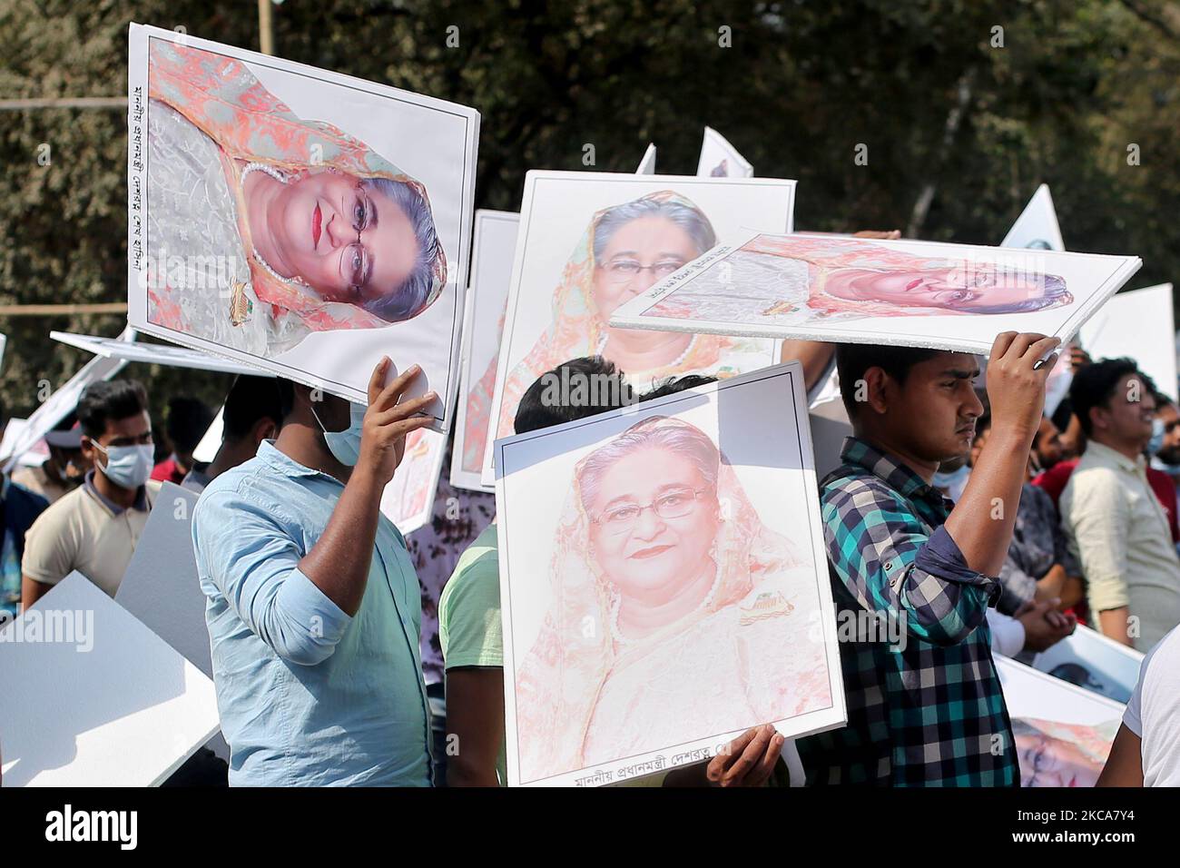 Members of the Bangladesh Chhatra League hold image placards of ...