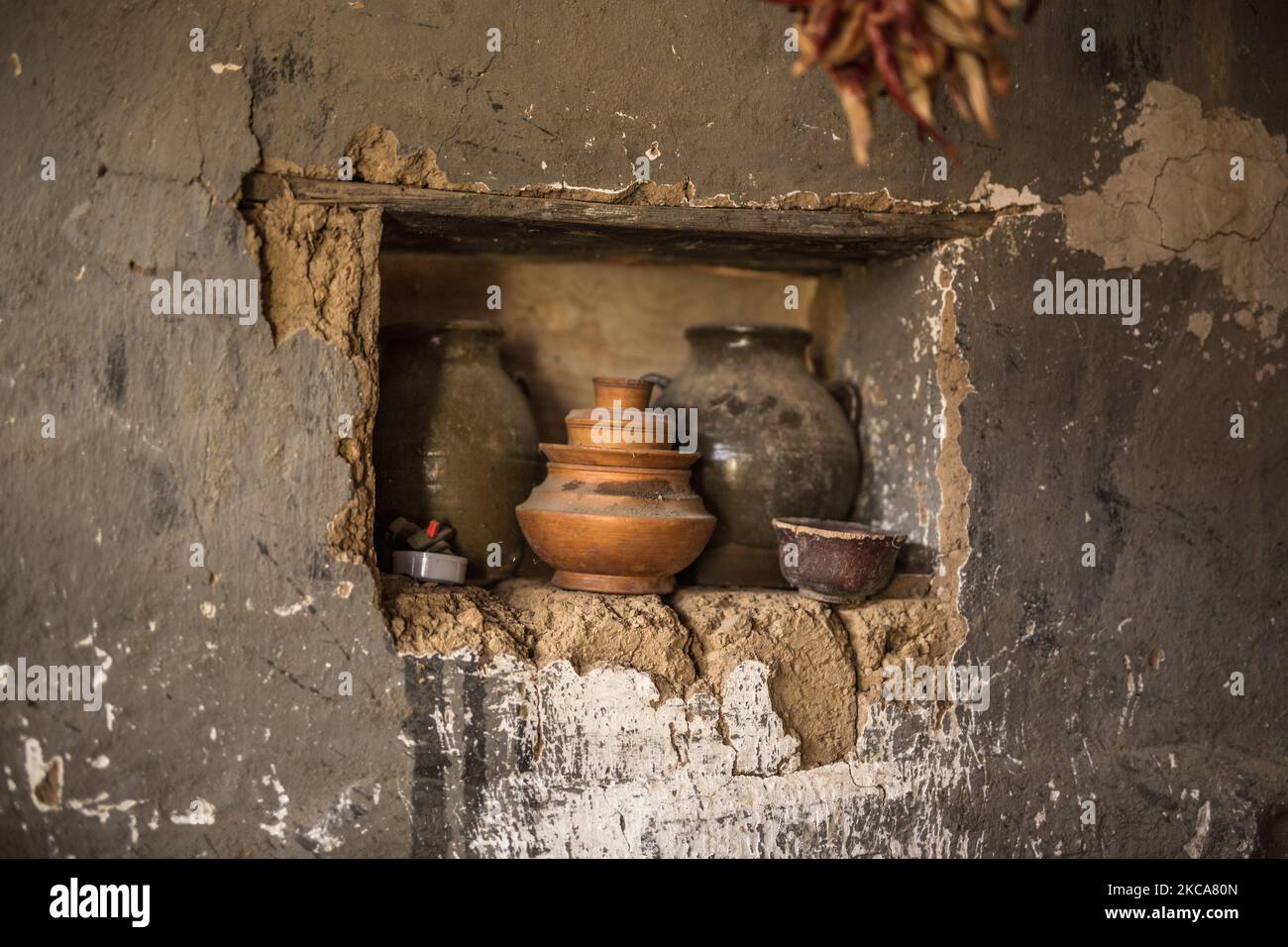 A hole in the wall of an old house with old household items Stock Photo ...
