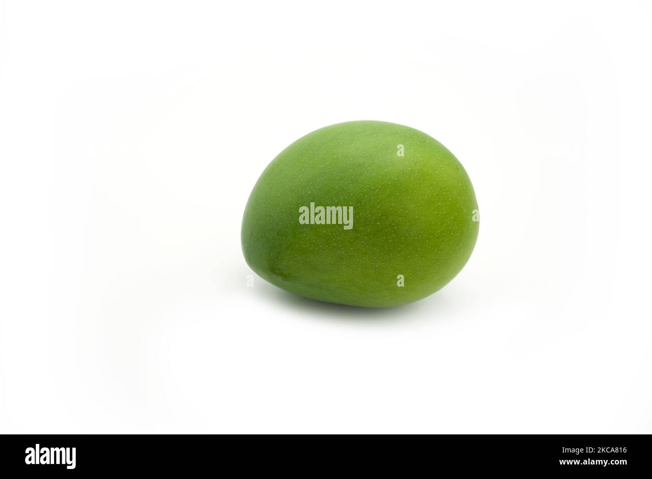 An unripe green mango isolated on a white background Stock Photo - Alamy