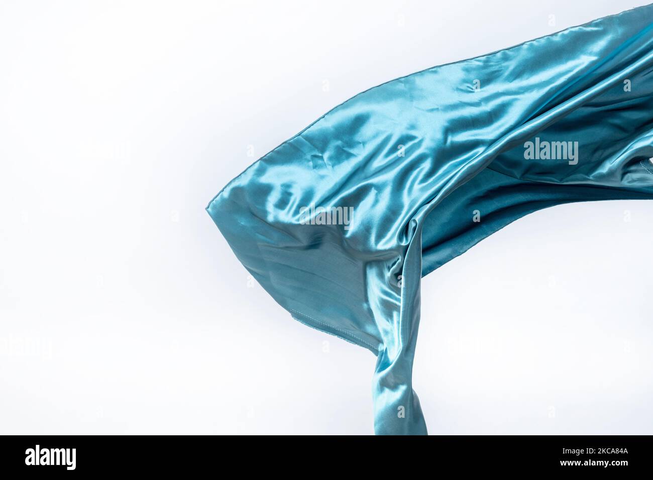 Bright green fabric background with some wrinkles and fluttered by a ...