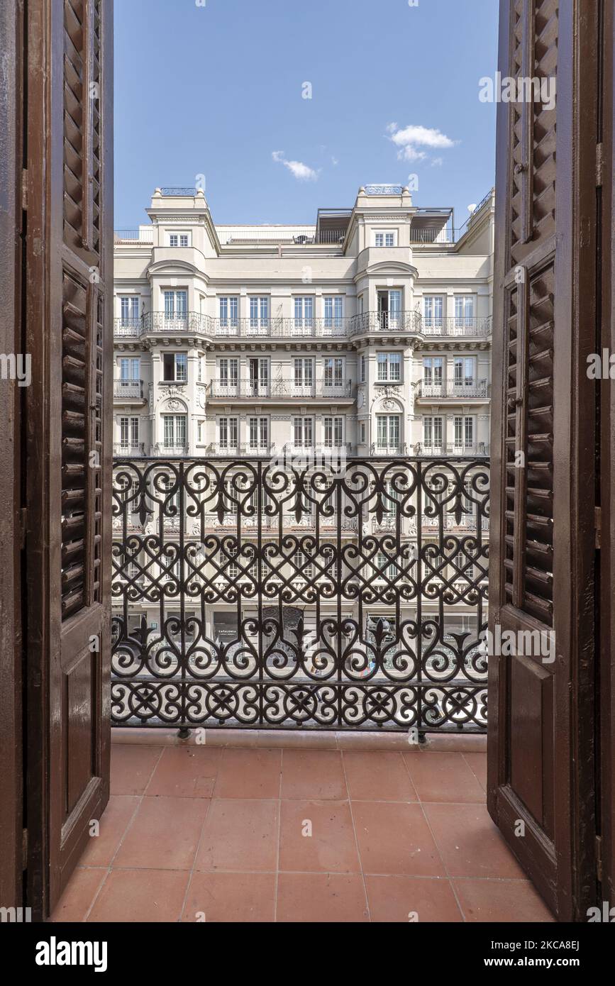 Views of a building with a white facade through the windows of a ...