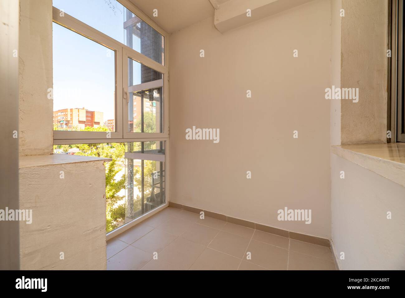 Small empty terrace of a house closed with white aluminum and views of ...