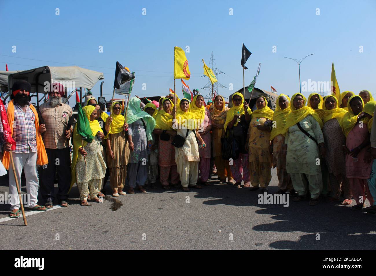 Women along with farmers take part in a protest by blocking KMP ...