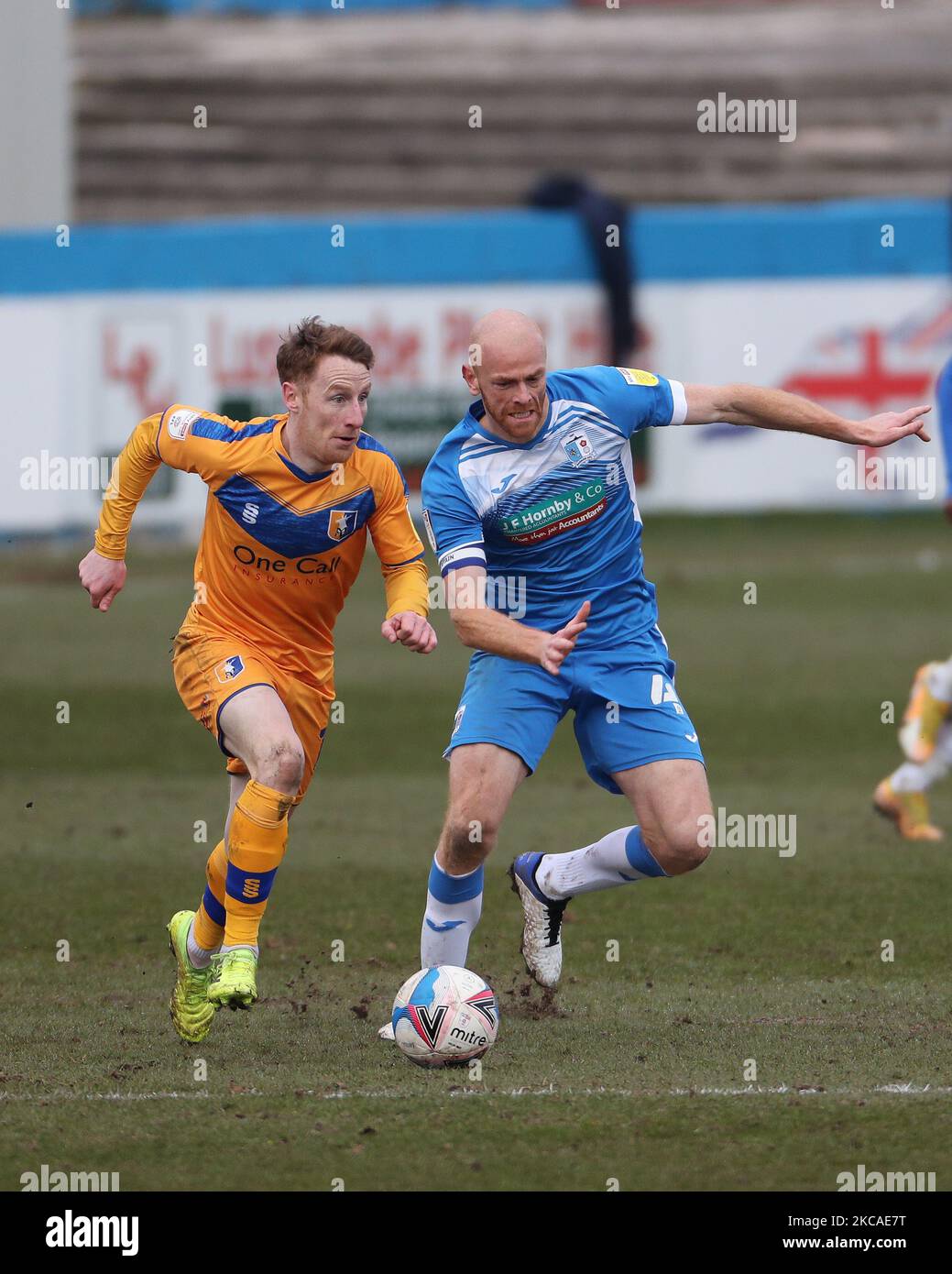 Stephen Quinn of Mansfield Town in action with Barrow's Jason Taylor ...