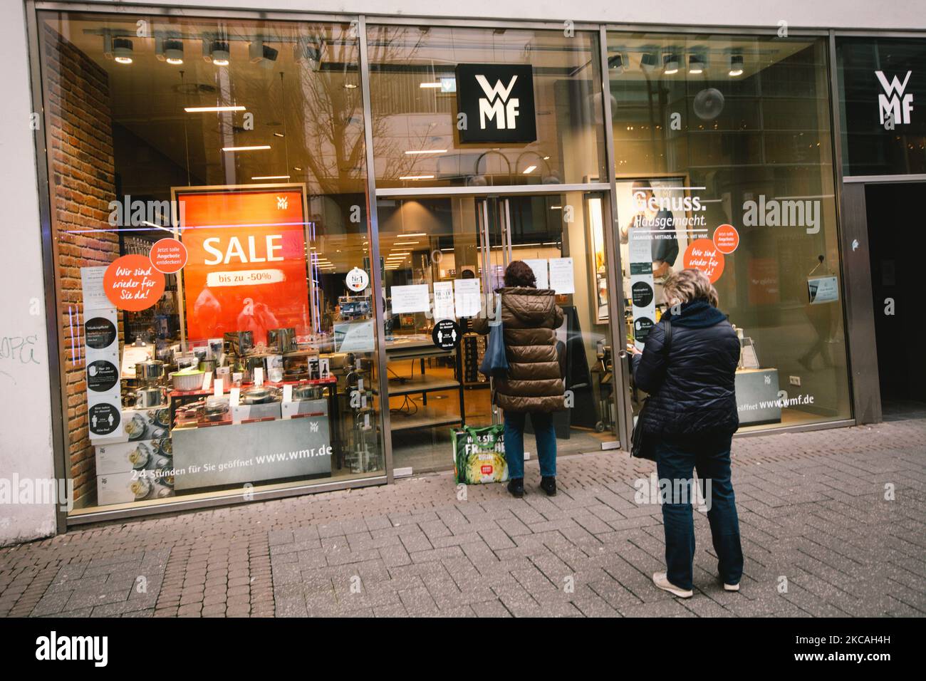 people wait in line to get inside of WMF store in Cologne, Germany on ...