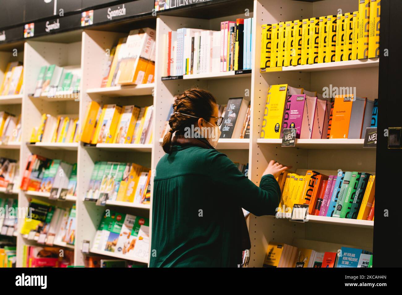 a employee organizes the books inside of Mayersche Koeln bookstore in ...