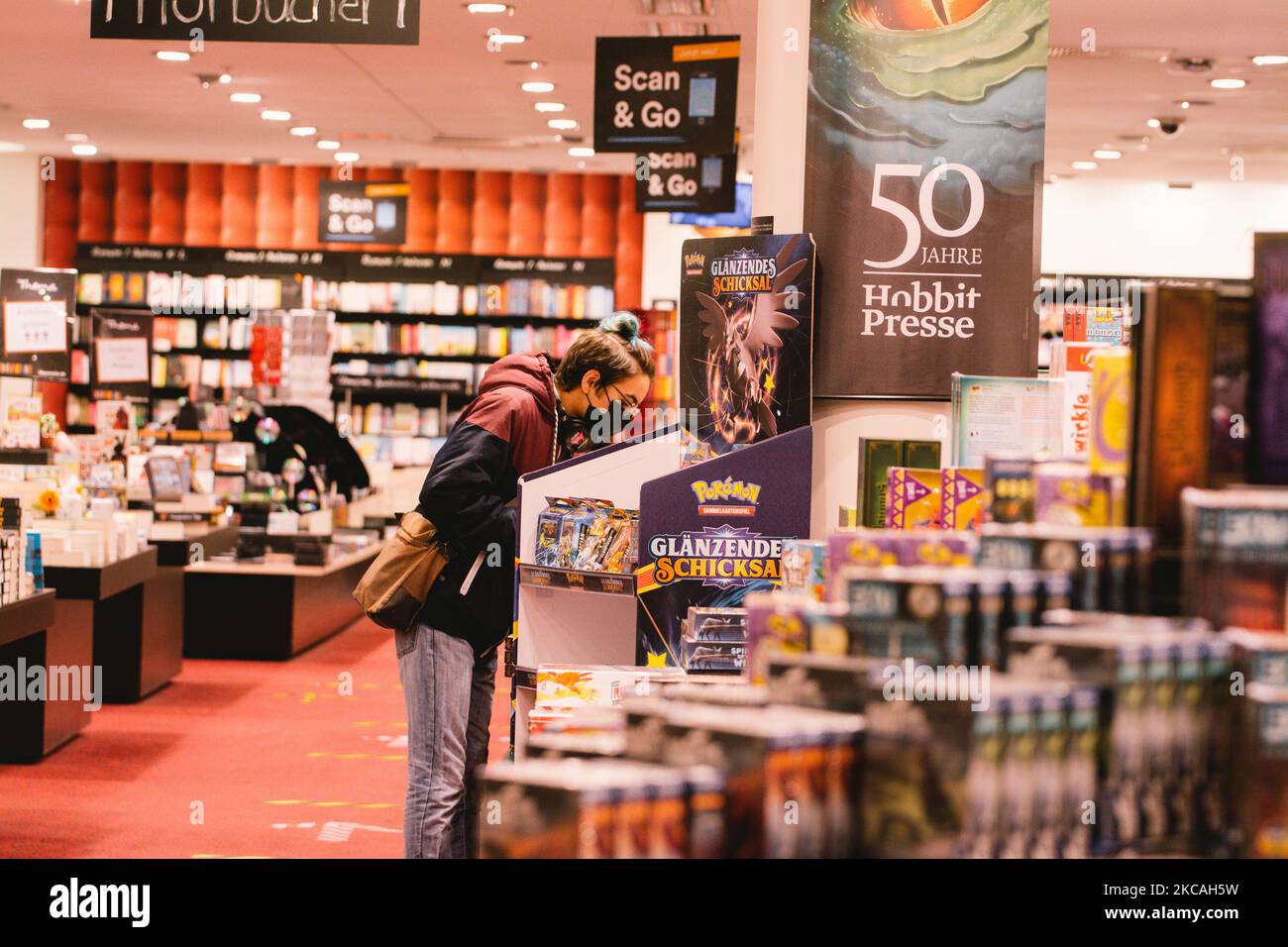 a customer checks the book inside the Mayersche Koeln bookstore in ...