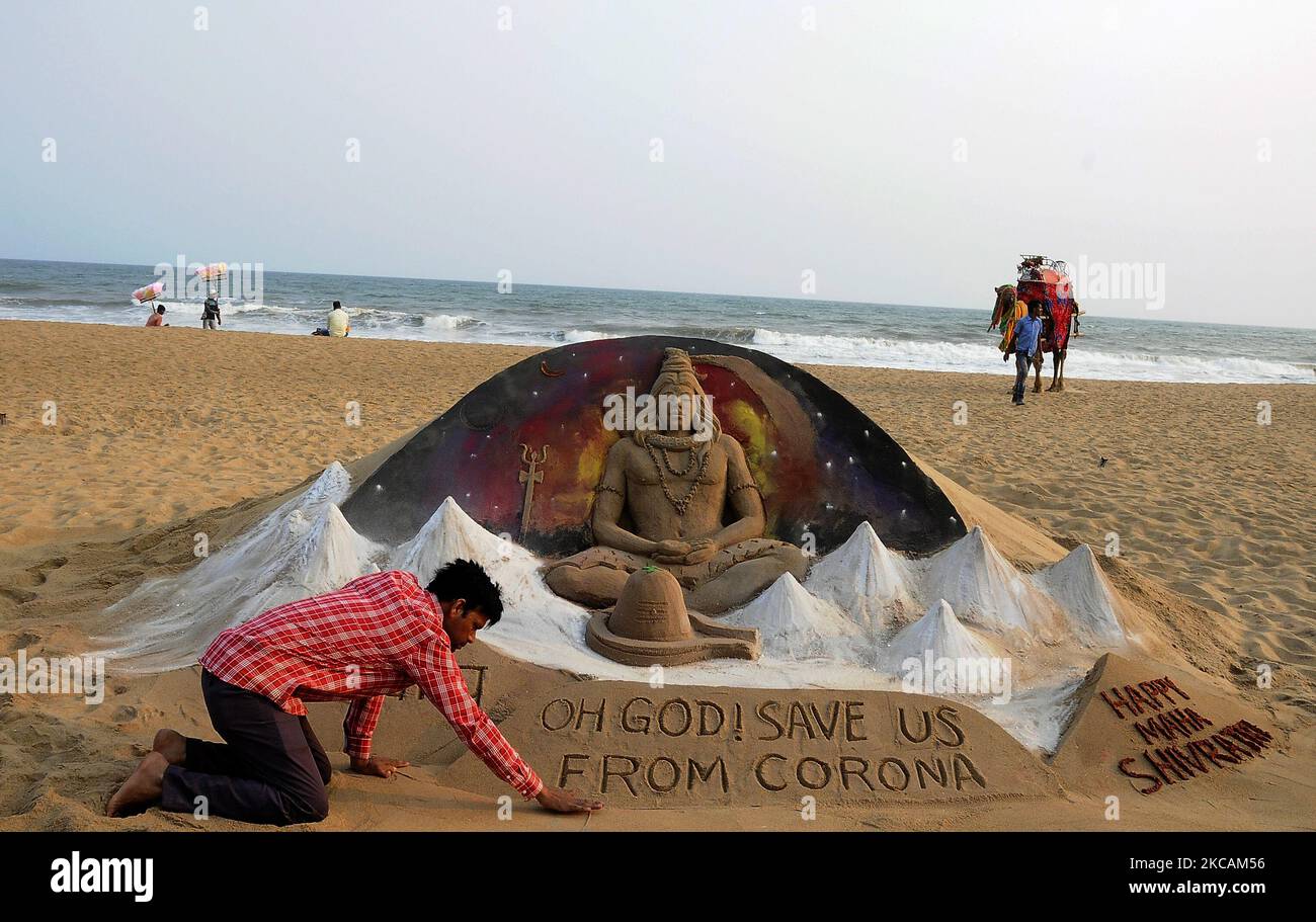 A sand sculpture is seen at the Bay of Bengal Sea's eastern coast beach ...