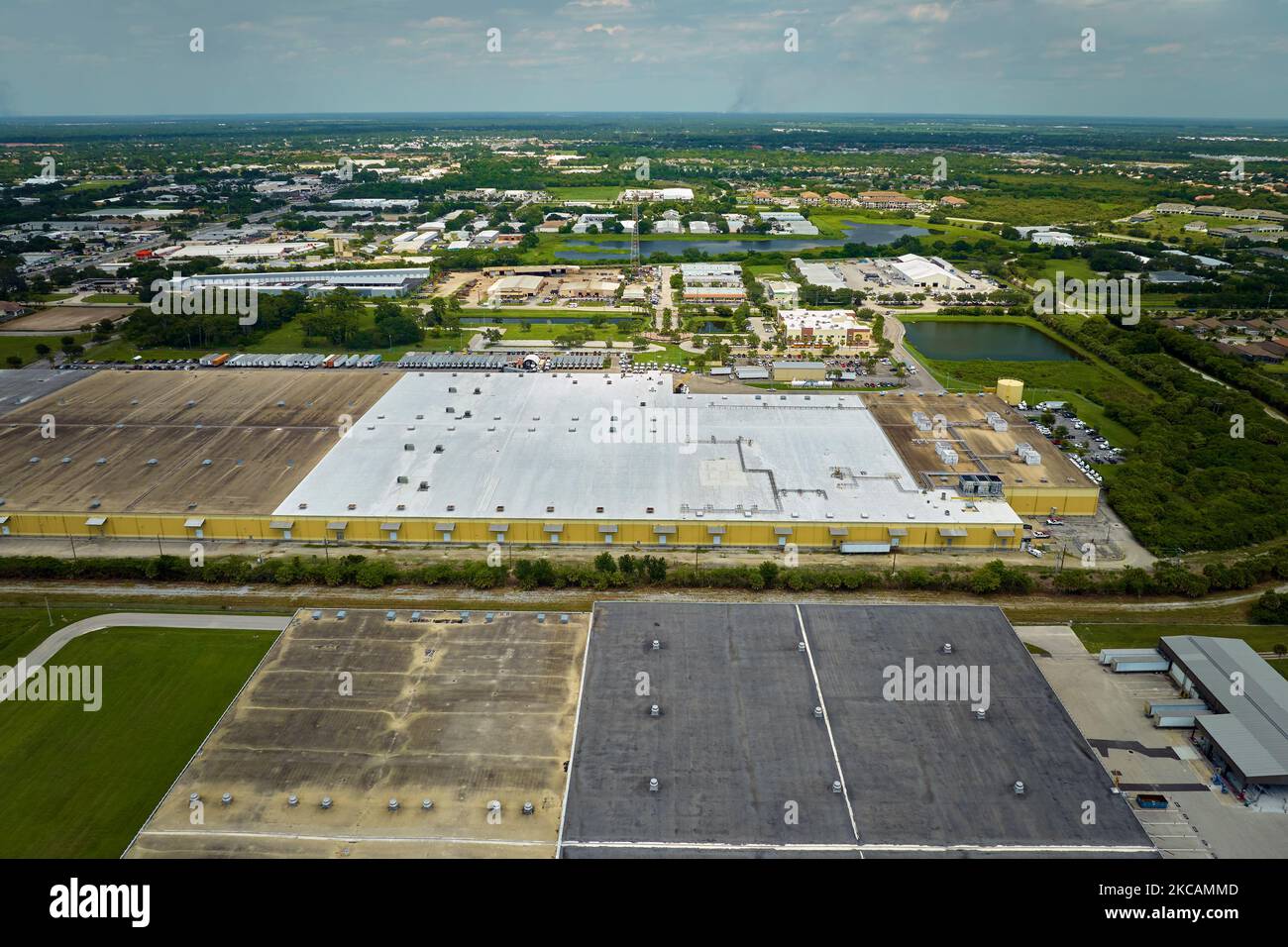 Big corporate shipment center with many cargo semi trucks unloading and ...