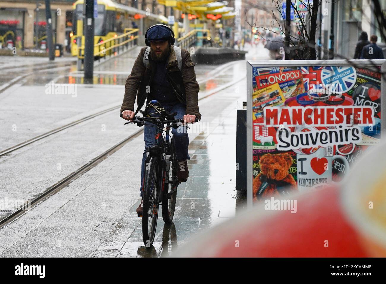 A man rides a bicycle in central Manchester on 10 March 2021. (Photo by ...