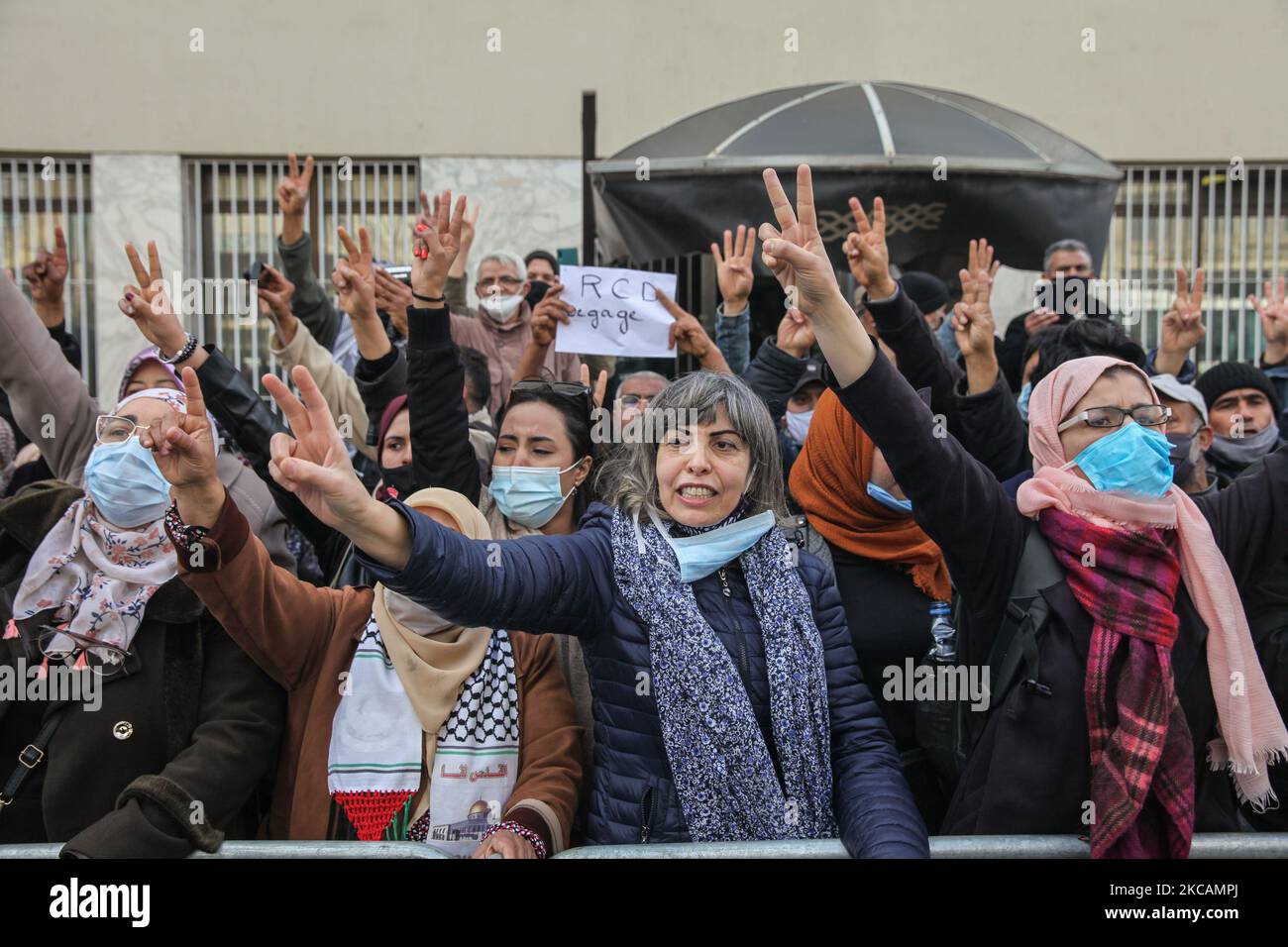 Protesters from Islamist movements lift victory sign (V sign) and give ...