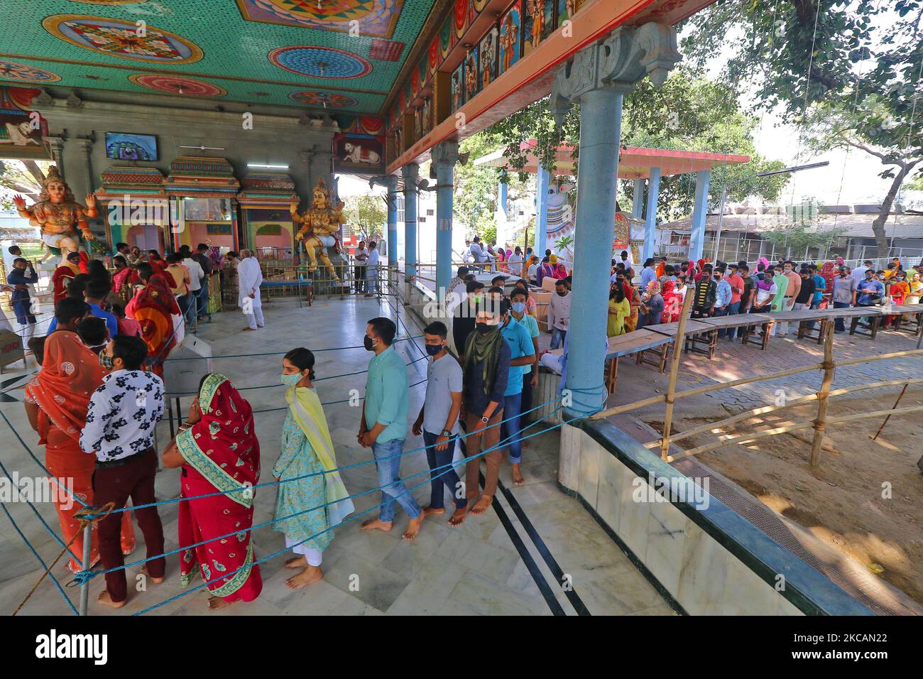 Devotees stand in a queue to offer prayers to Lord Shiva on the ...