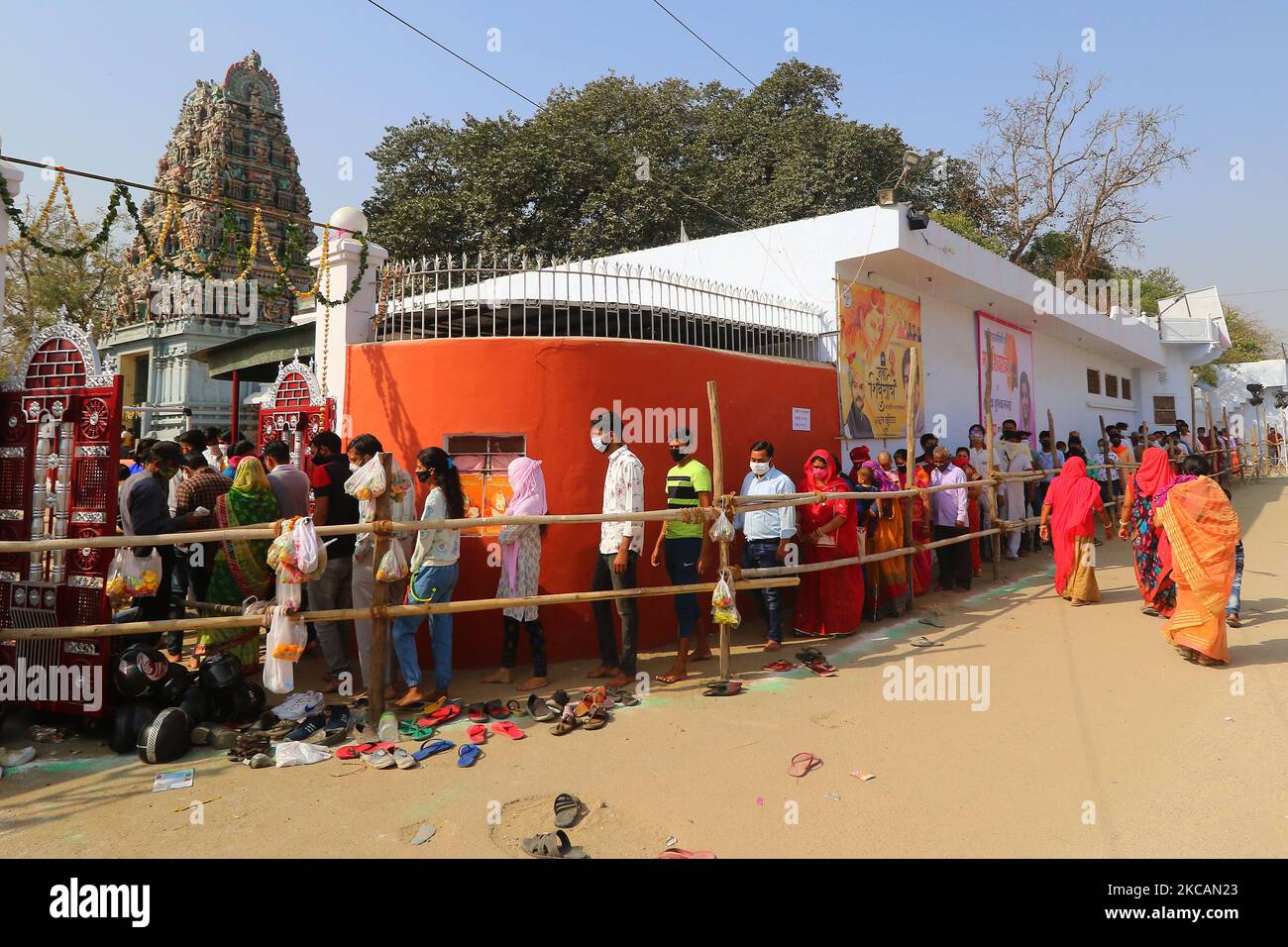 Devotees stand in a queue to offer prayers to Lord Shiva on the ...