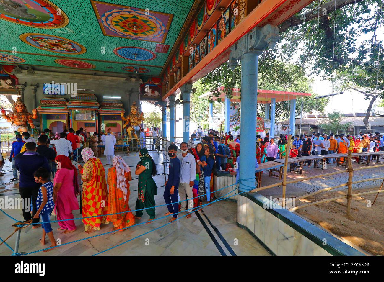 Devotees stand in a queue to offer prayers to Lord Shiva on the ...