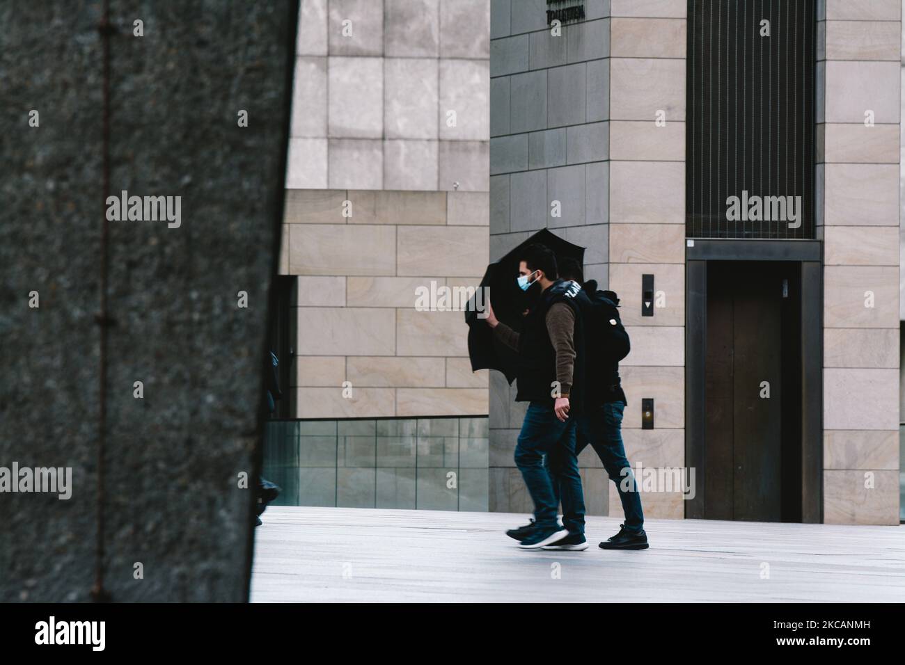 people walks against strong wind in front of Dom Cathedral in Cologne ...