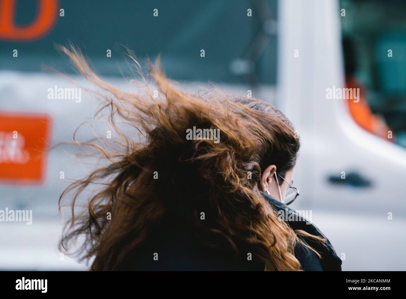 a woman's hair blows in th wind in front of Dom Cathedral in Cologne ...