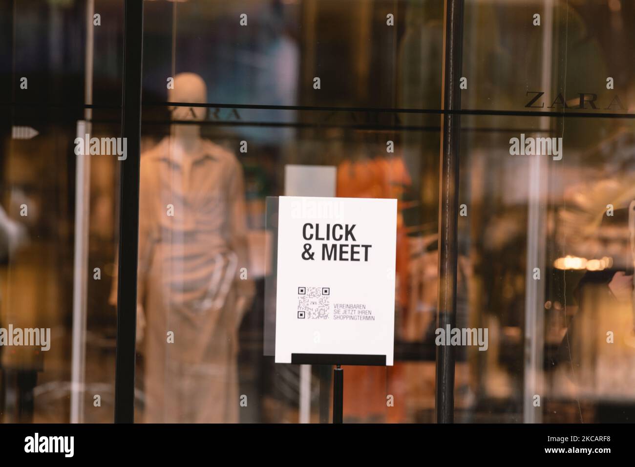 " Click & Meet" sign is seen in front of a clothing store in the city ...