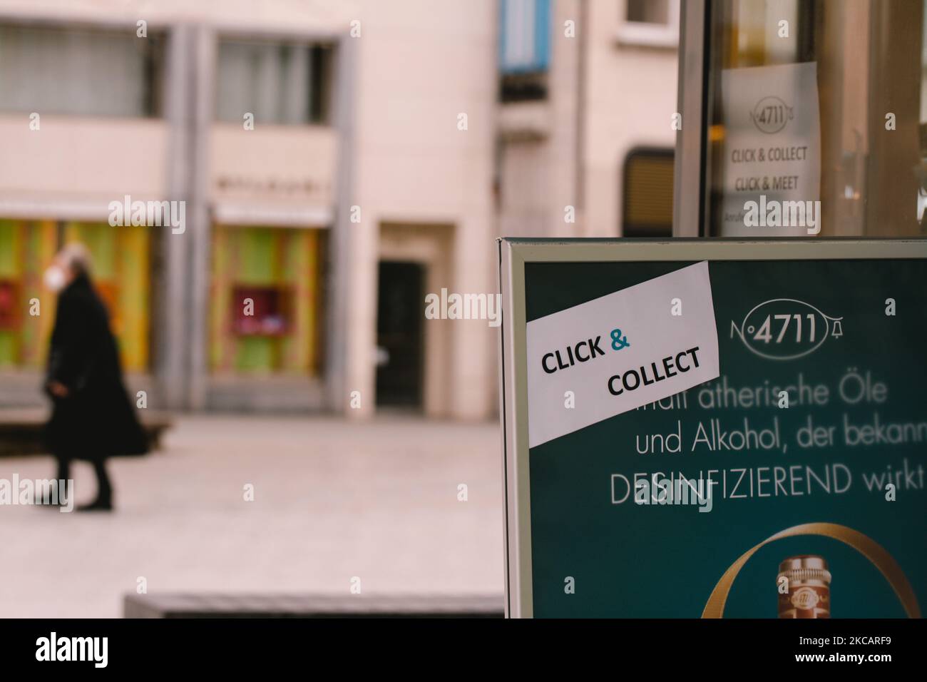 " Click & Collect " sign is seen placing on a placard of perfume store ...