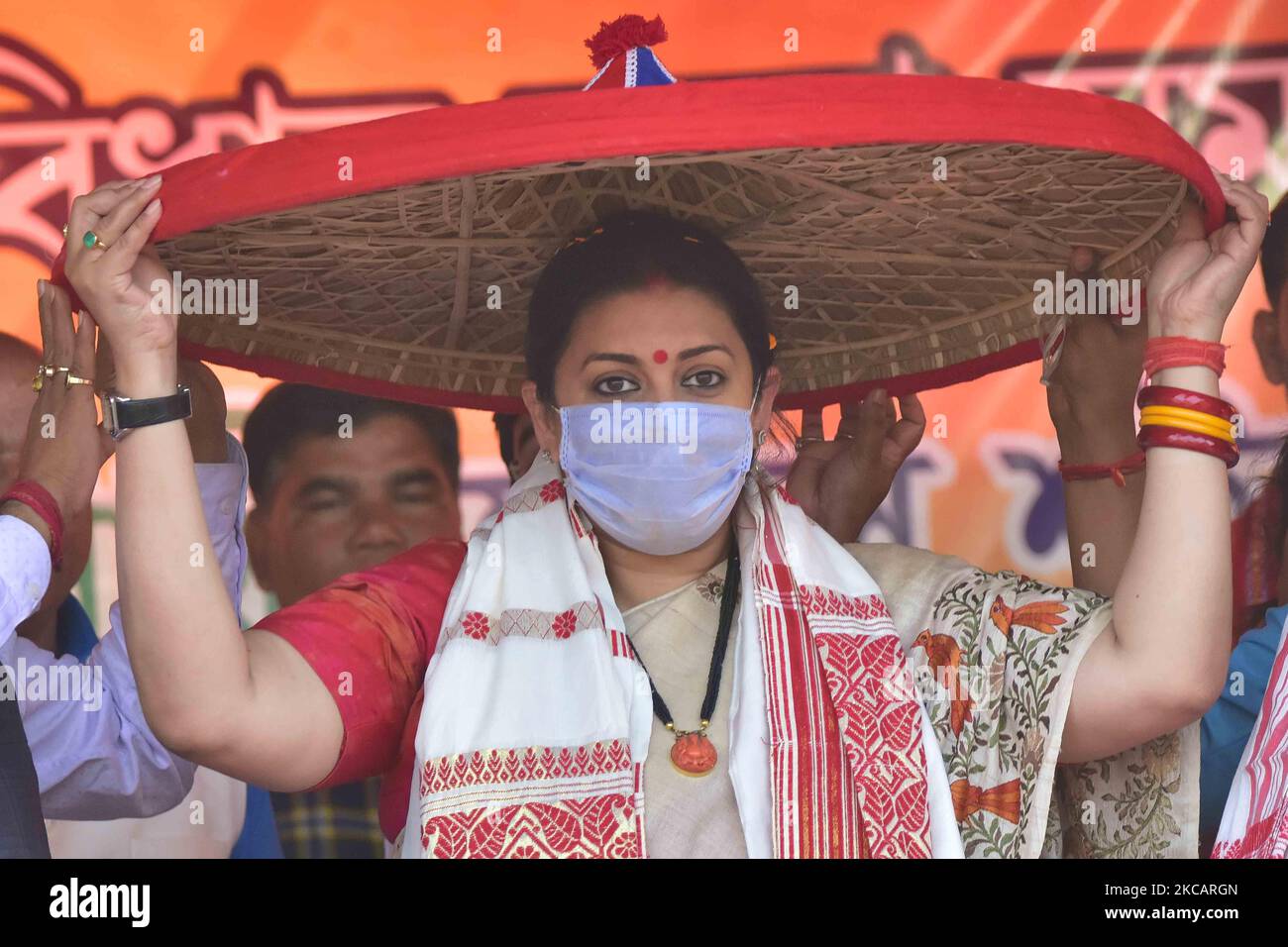 Union Minister Smriti Irani being presented an Assamese japi during an ...