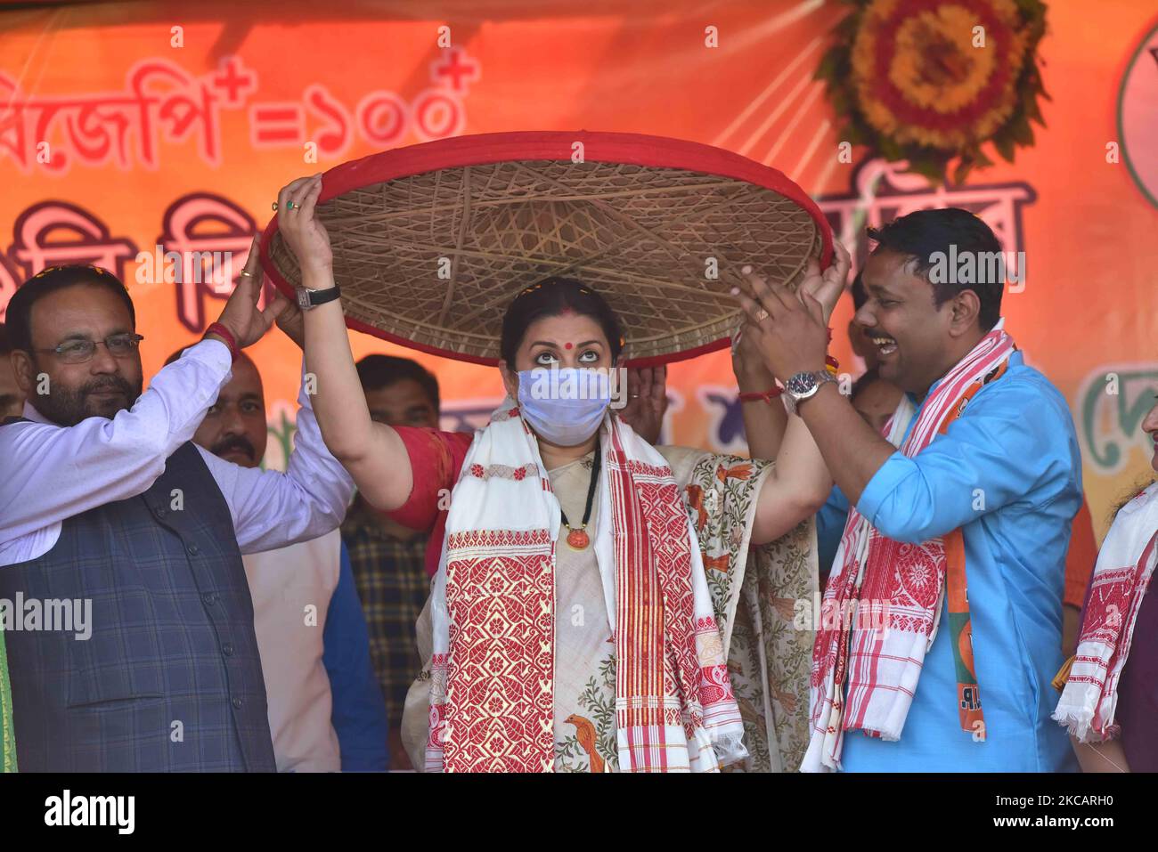 Union Minister Smriti Irani being presented an Assamese japi during an ...