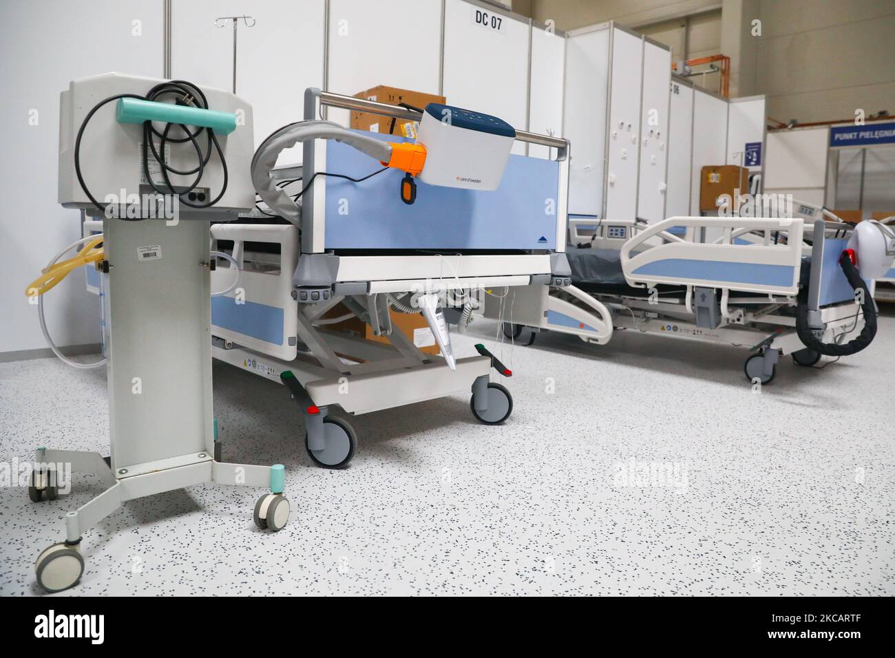 Hospital beds and rooms are under preparation inside a temporary ...