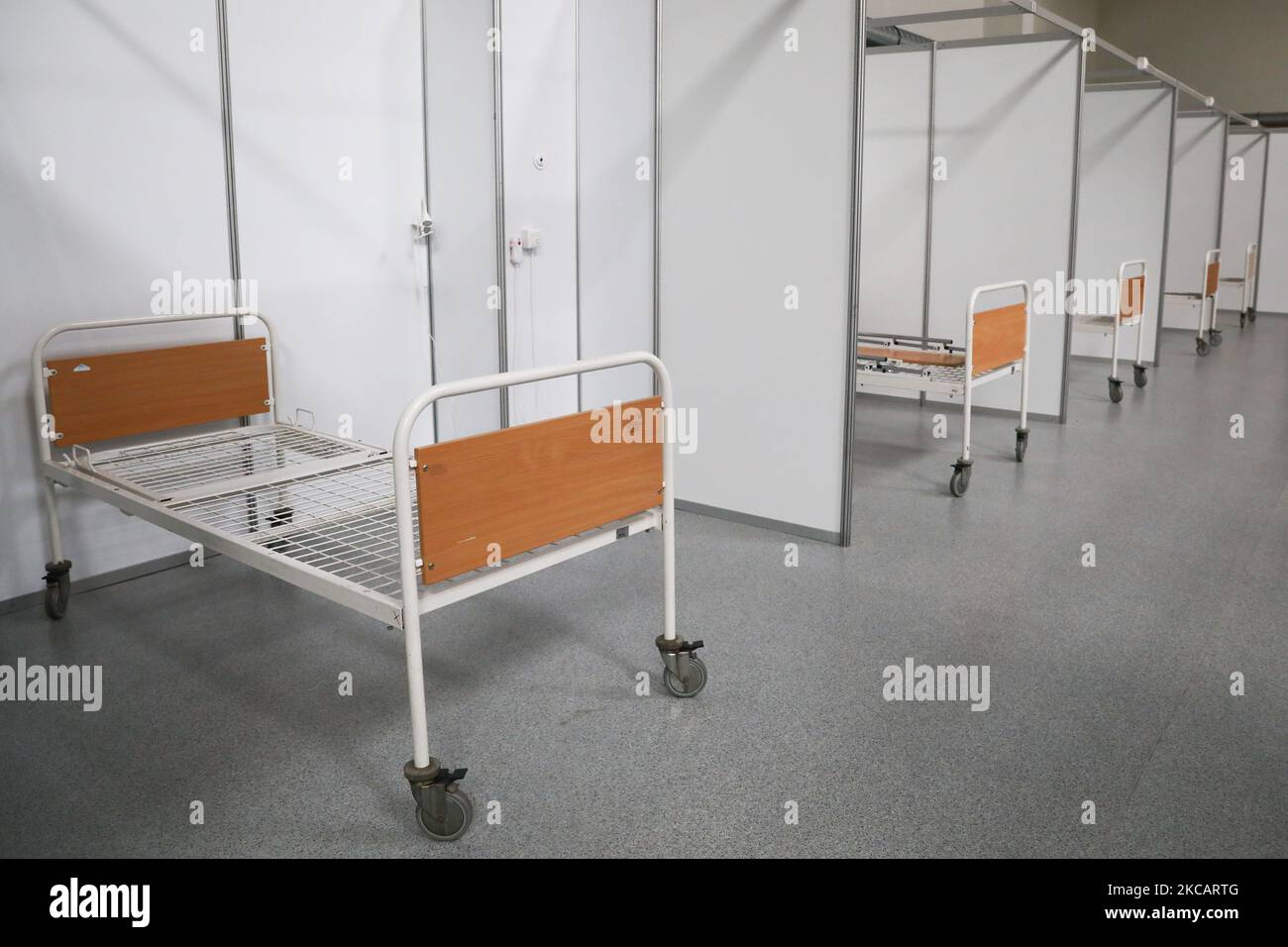 Hospital beds and rooms are under preparation inside a temporary ...