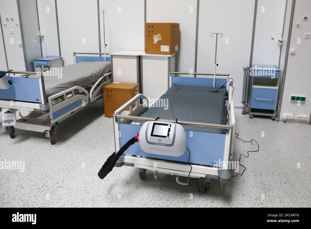 Hospital beds and rooms are under preparation inside a temporary ...