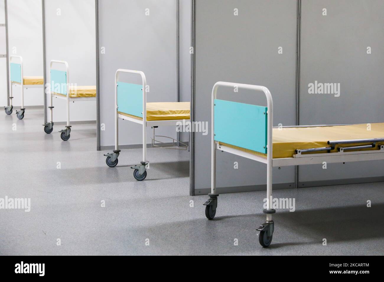 Hospital beds and rooms are under preparation inside a temporary ...