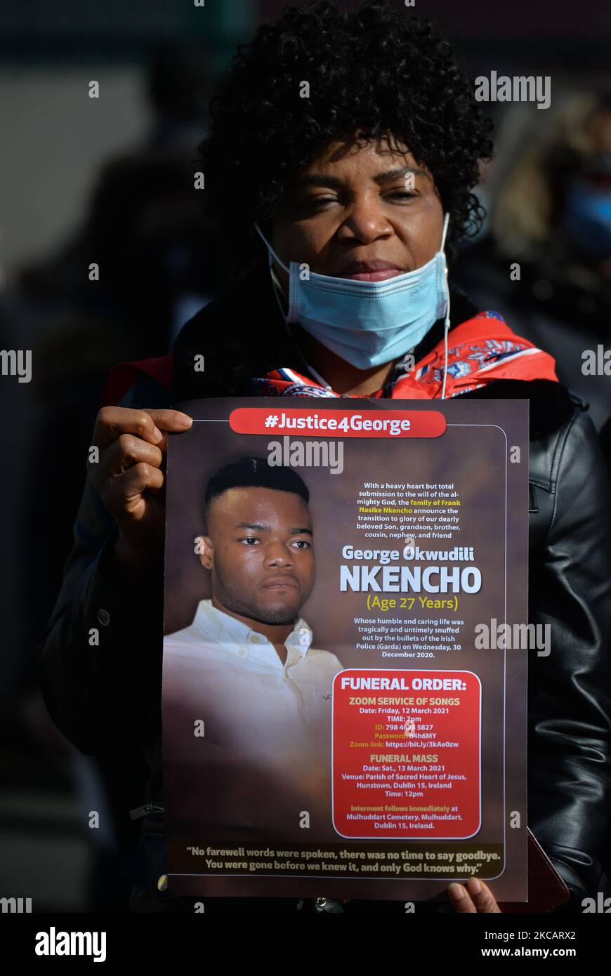 A woman holds a poster with an image of George Nkencho outside the ...