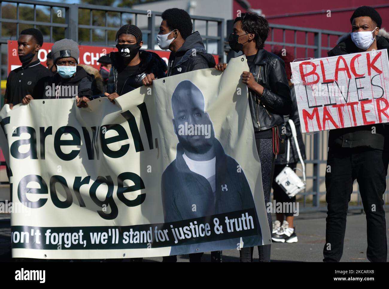 Mourners gather outside as the coffin of George Nkencho, a 27-year-old ...