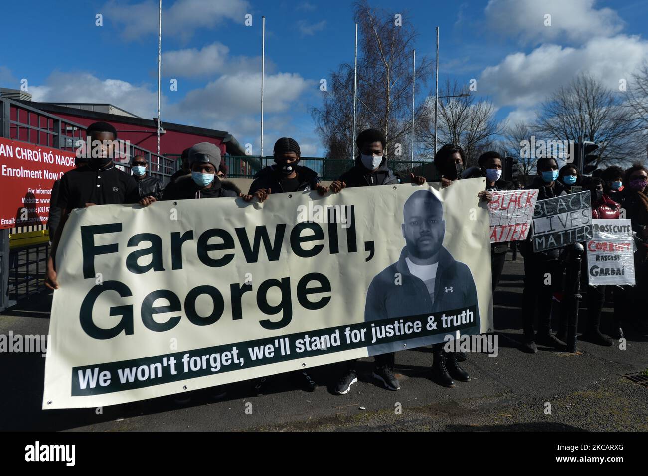 Mourners gather outside as the coffin of George Nkencho, a 27-year-old ...