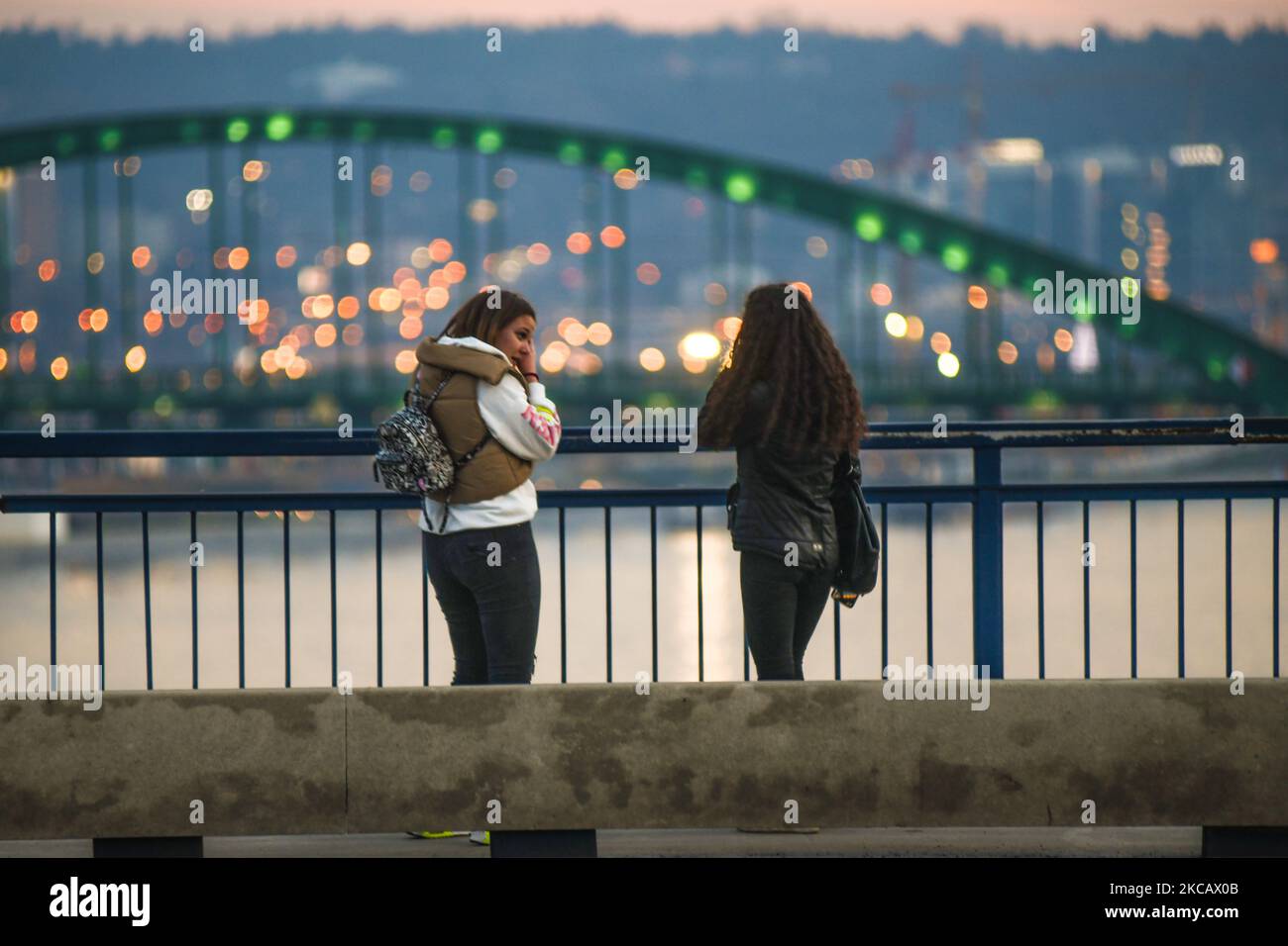 Belgrade: girls talking in Brankov Most (bridge) in the evening, with ...