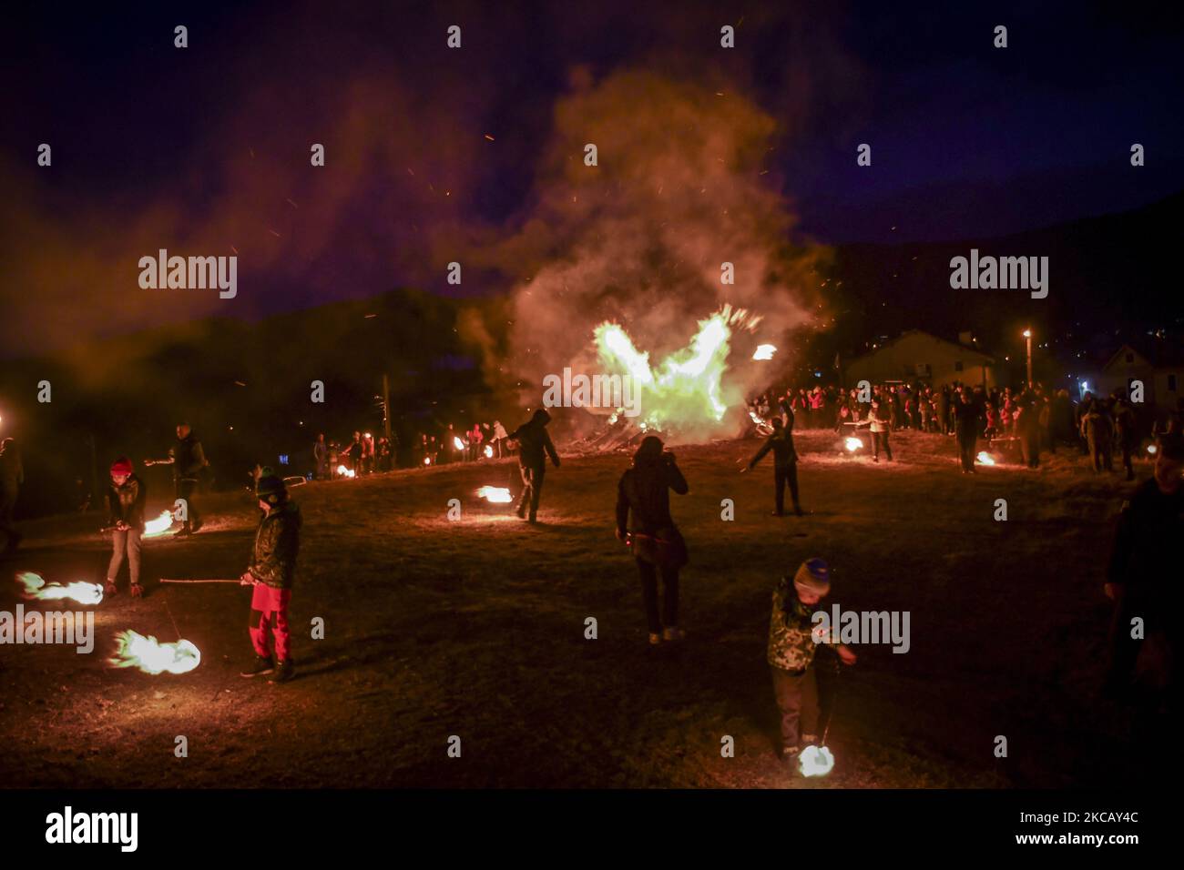 Children are playing with fireballs near a bonfire during the ...