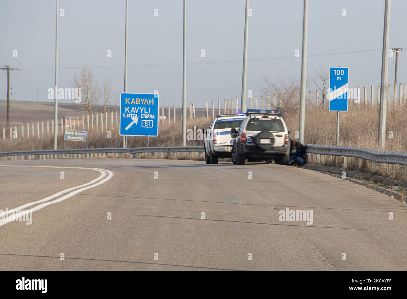 Police cars and law enforcement officers are seen holding 2 ...