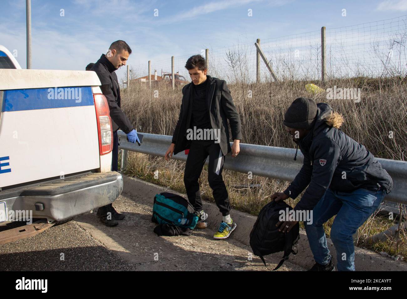 Police cars and law enforcement officers are seen holding 2 ...