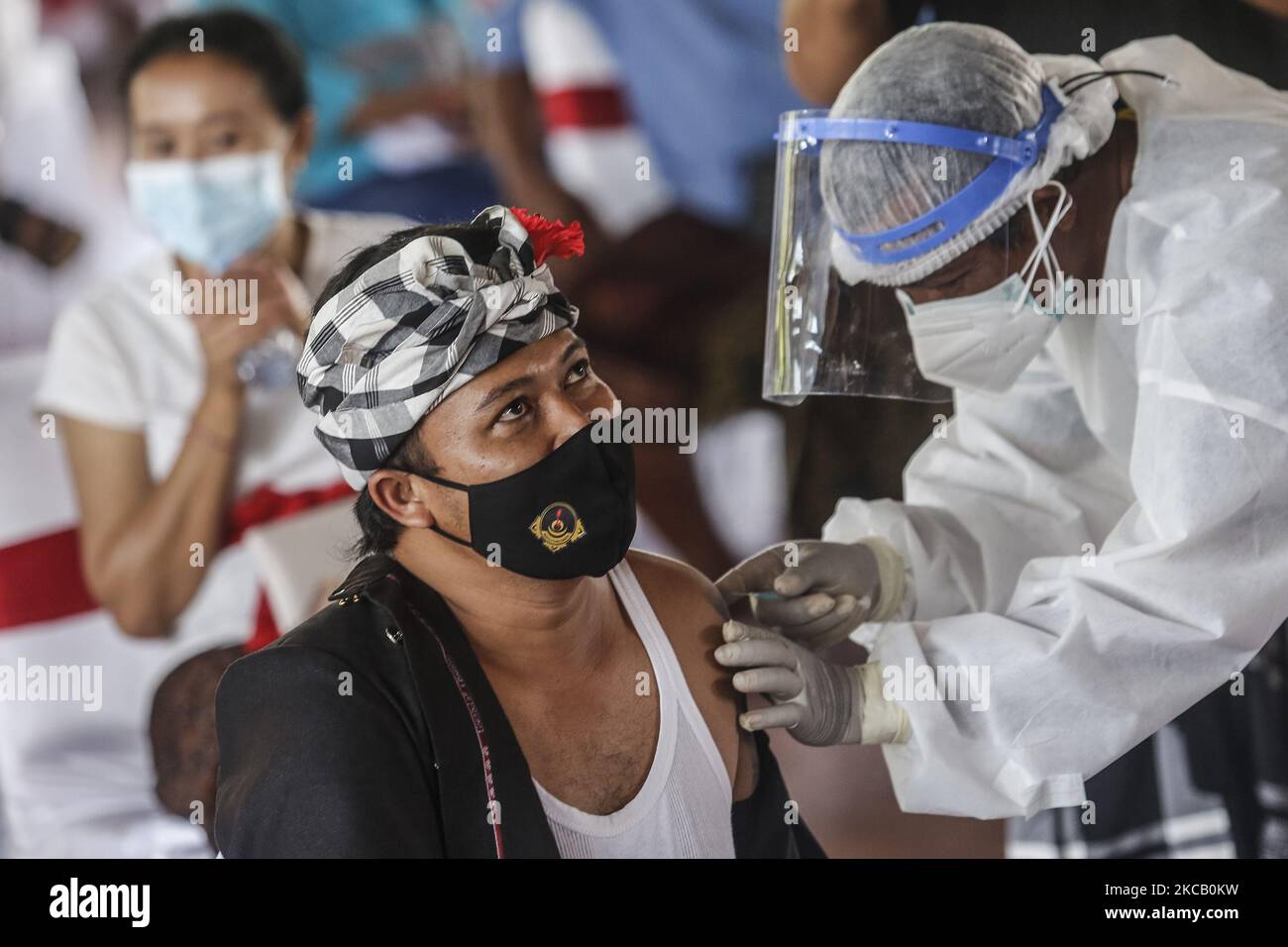 Balinese traditional guard known as Pecalang receives a dose of Sinovac ...