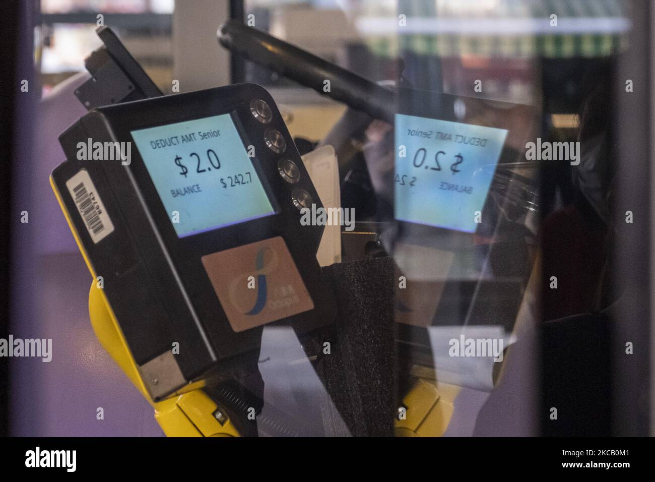 An Octopus card machine on a bus display a fare charge of HK$2.00 a ...