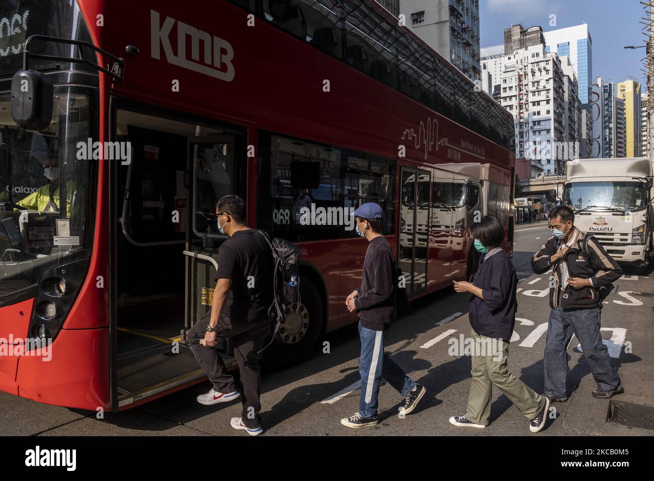 Commuters board a bus operated by KMB Bus company in Hong Kong, Tuesday, March 13, 2021. Today ...