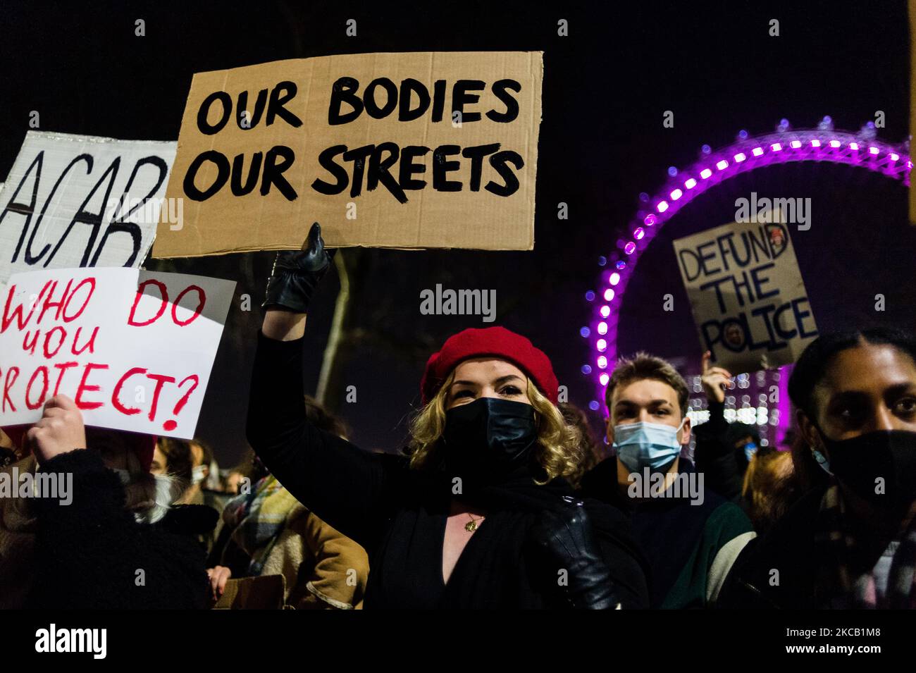 People hold placards during a demonstration at Parliament Square ...