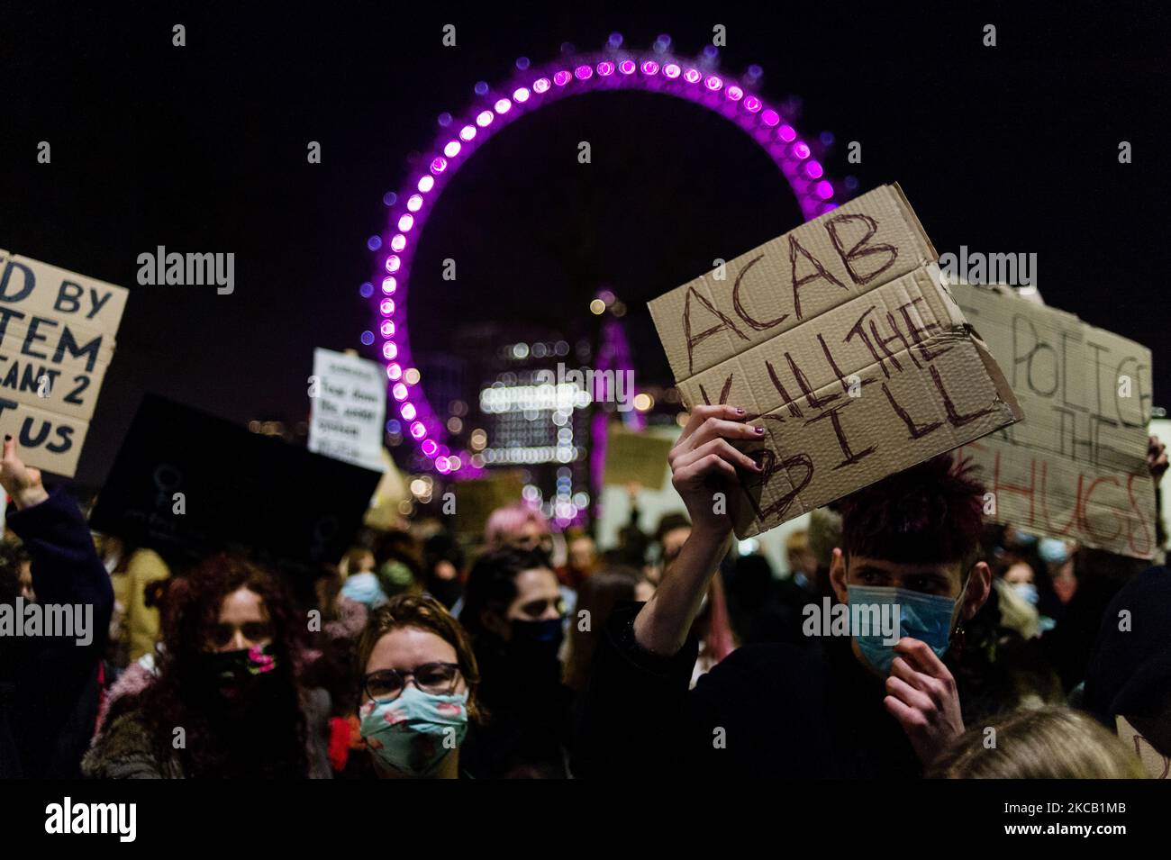 People hold placards during a demonstration at Parliament Square ...