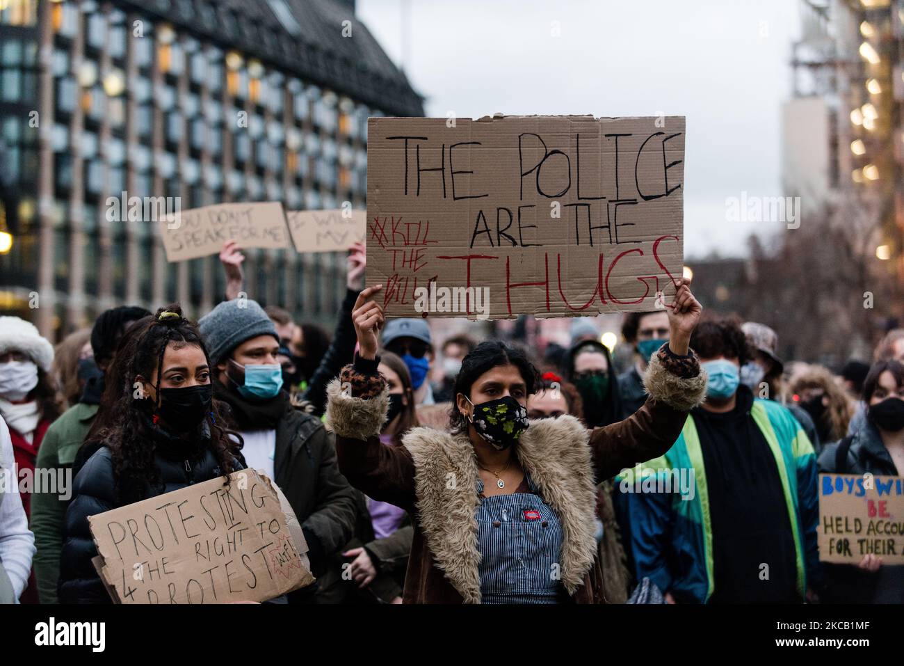 People hold placards during a demonstration at Parliament Square ...