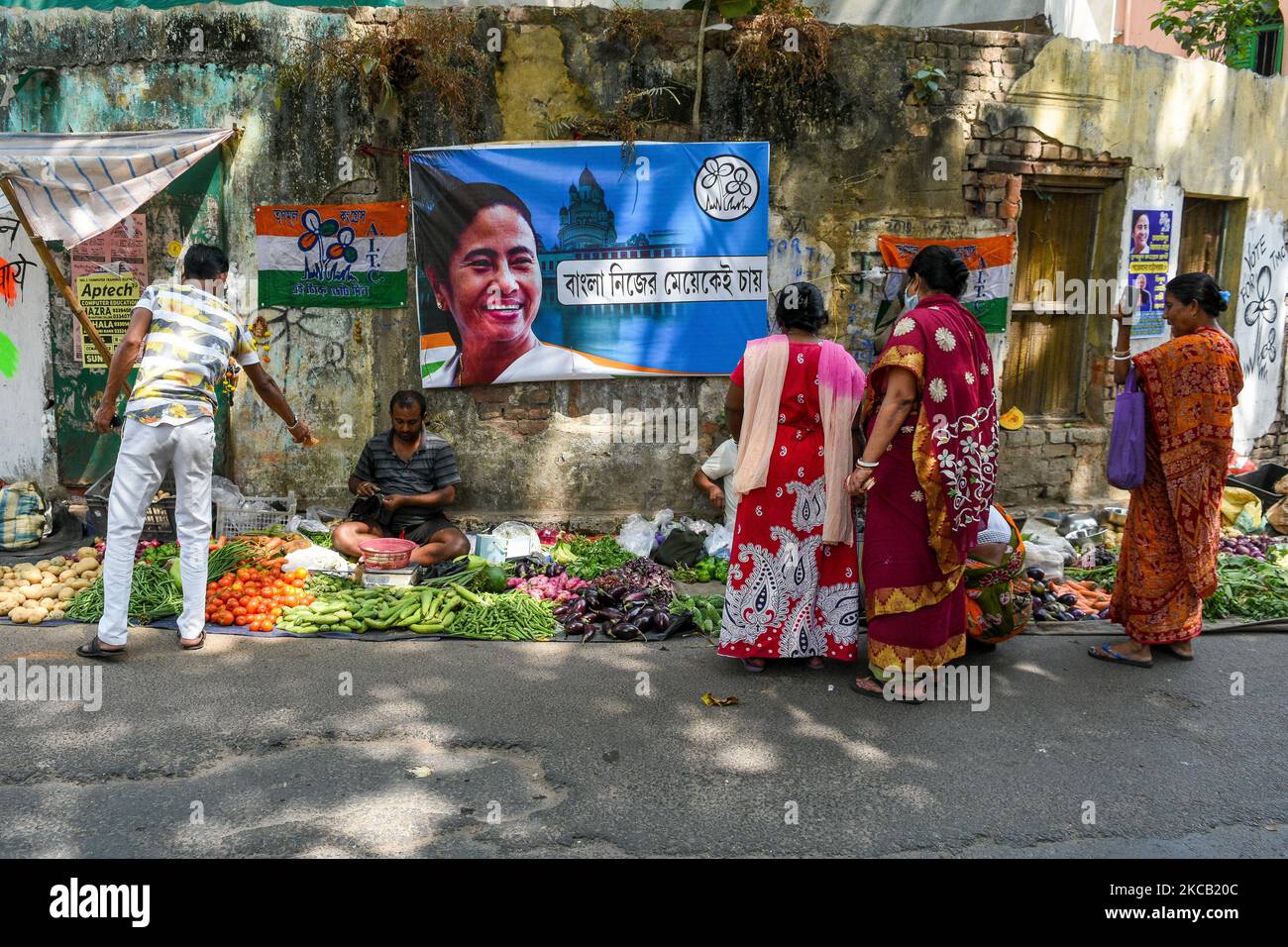 Farmers selling various vegetables at a market place with various ...