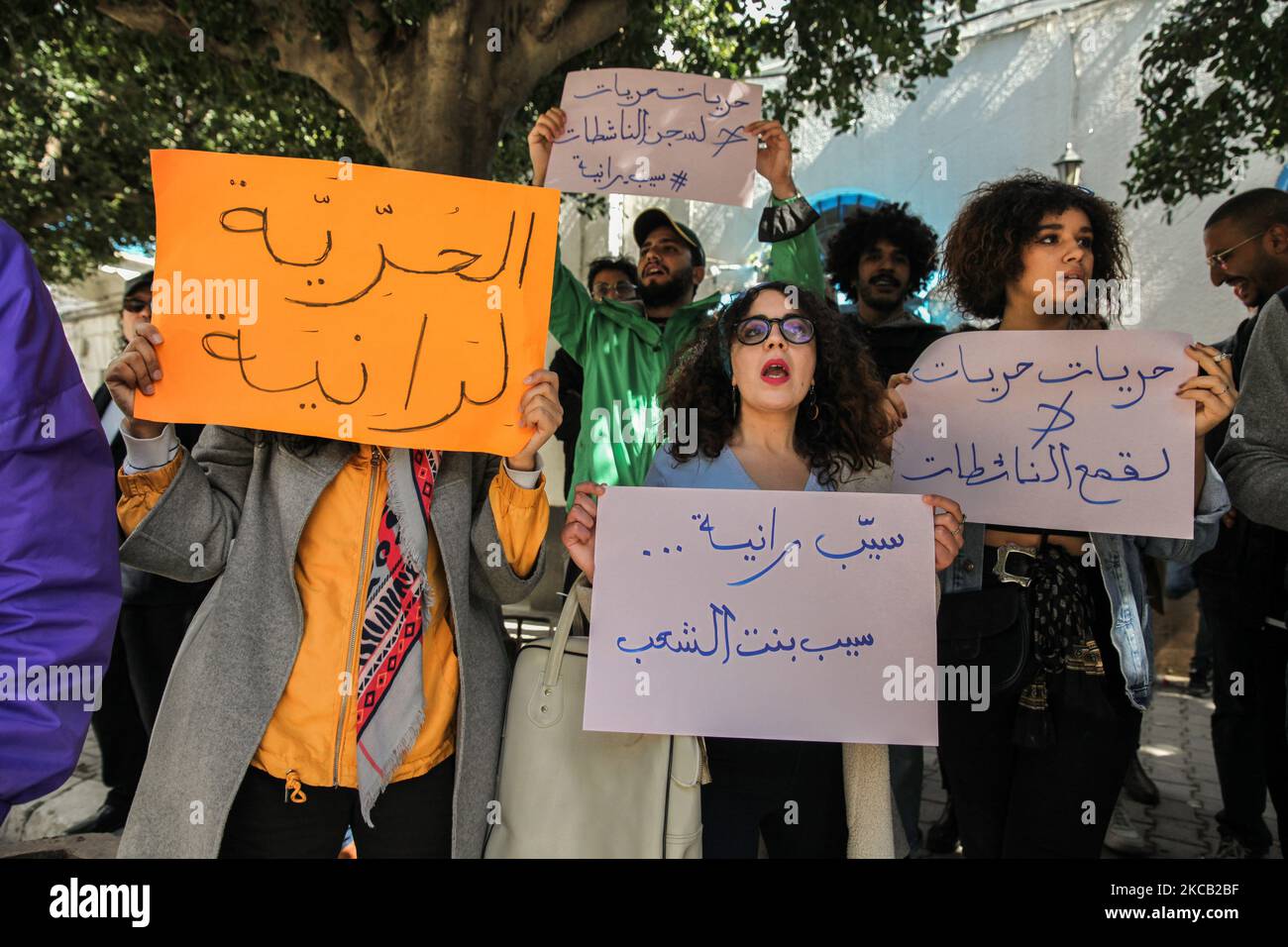 Protesters raise placards that read in Arabic, “Release Rania Amdouni ...